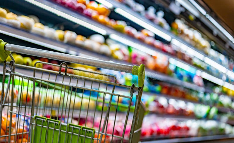 A Shopping Cart by a Store Shelf in a Supermarket Stock Photo - Image ...