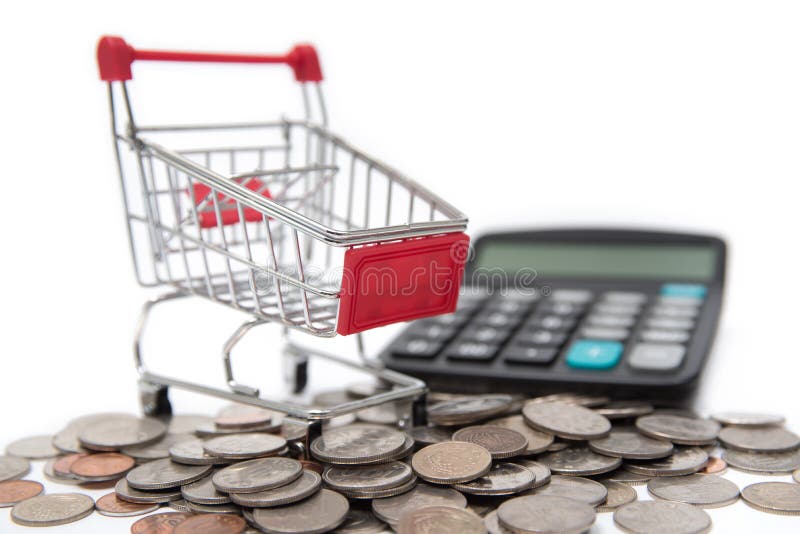 Shopping Carts and Calculator Over Stacked Coins and Banknotes Stock ...