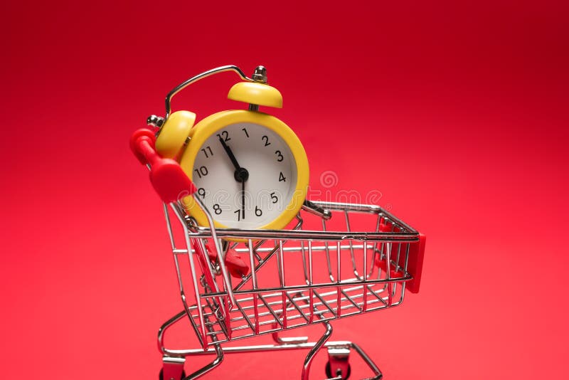 Shopping Time. Yellow Alarm Clock in Shopping Basket on a Red ...