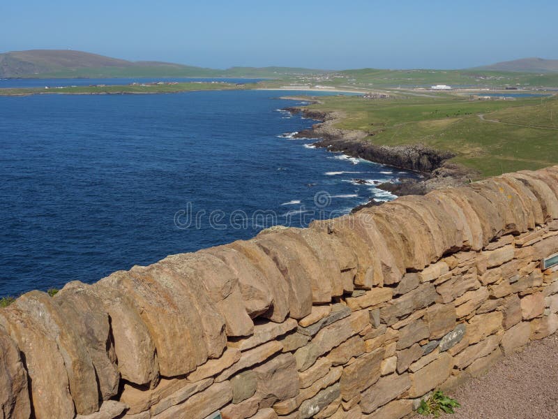Shore Decorated with a Fence and Deep Blue Sea in the Background Stock ...