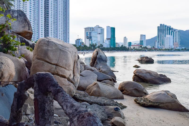 Shore of Sea with Stones and Tall Modern Building on Background Stock ...