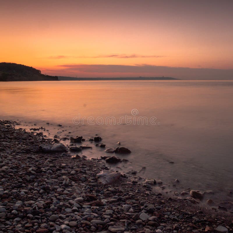 Shore at Sunset. Long Shutter Speed Stock Image - Image of water ...