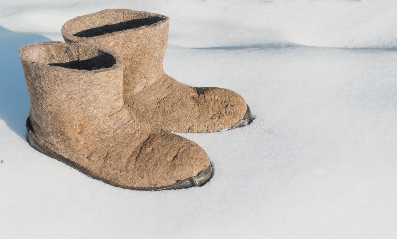 Short Felt Boots Stand in the Snow Stock Image - Image of warm, white ...