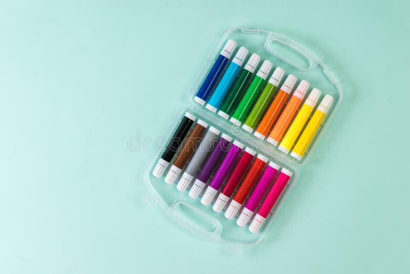 Short Multi-colored Markers in a Plastic Box on a Blue Background ...