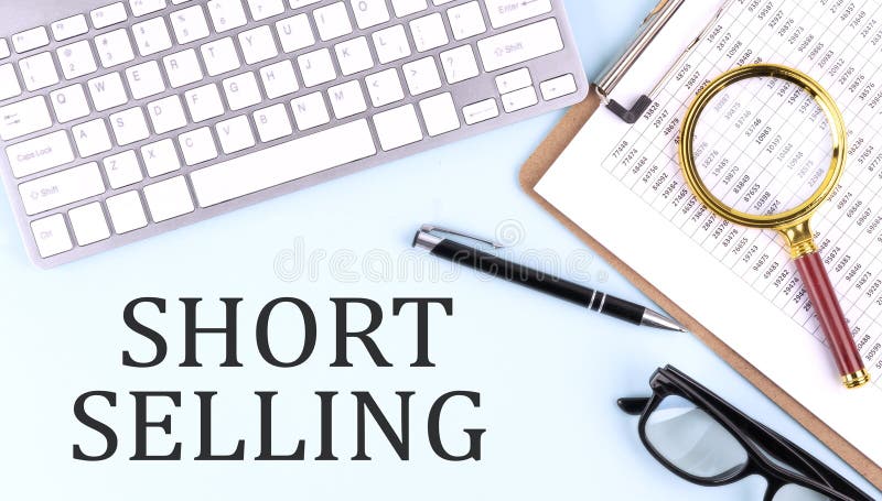 SHORT SELLING Text on Blue Background with Keyboard and Clipboard ...