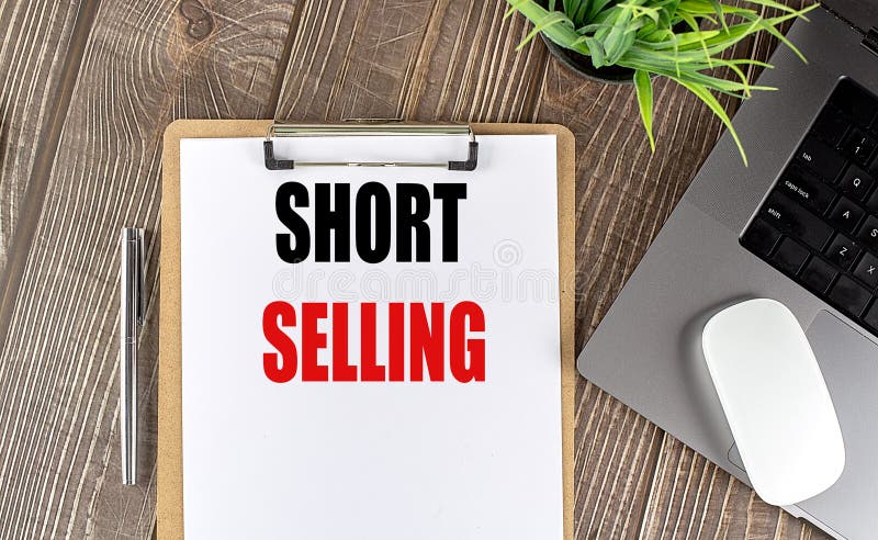 SHORT SELLING Text on Clipboard Paper with Laptop, Mouse and Pen Stock ...