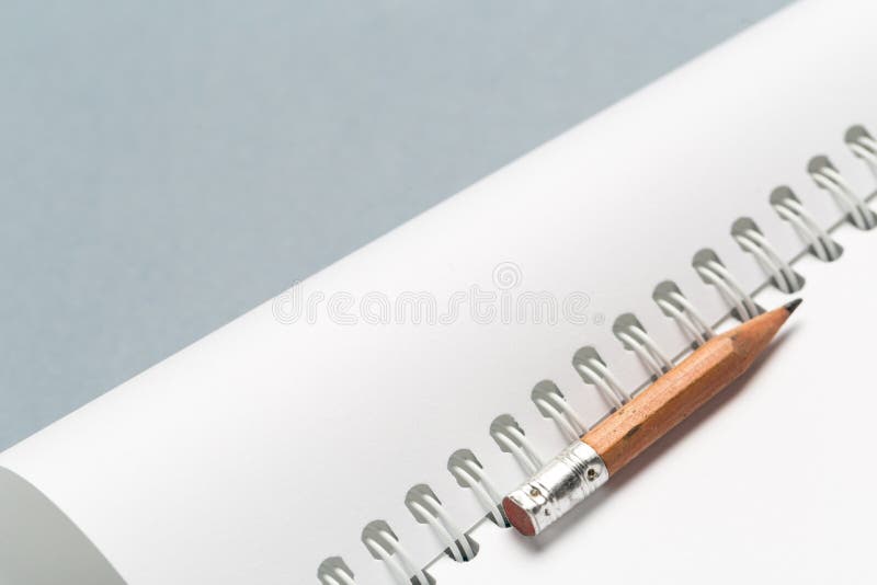 Short Worn Pencil with Notepad on Gray Desk Stock Image - Image of ...