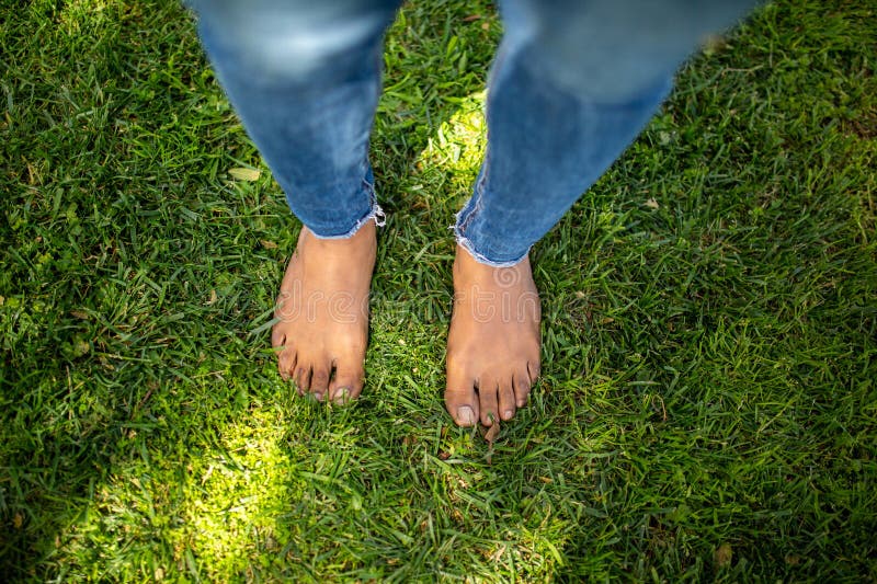 Female Feet Standing on Green Grass Stock Photo - Image of blue, legs ...