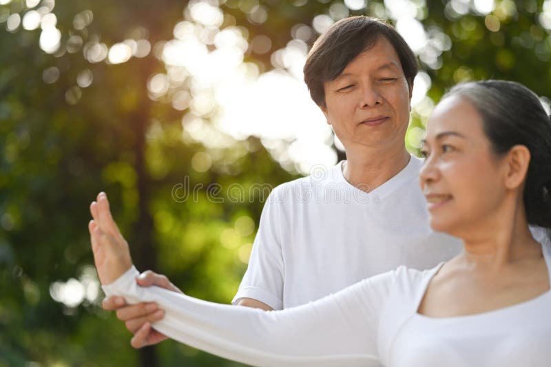 Shot of Active Middle Aged Couple Practicing Posture during Tai Chi ...