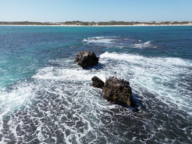 Shot of a Beach, Featuring Rocks and Crystal-clear Blue Water Stock ...