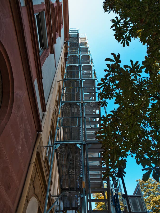 Shot from Below Up a Scaffolding on an Old Building that is on the Left ...