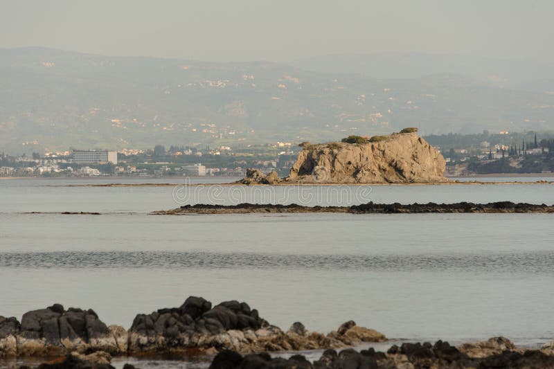 Shot of Rocks on Seashore with Houses on Background Stock Image - Image ...