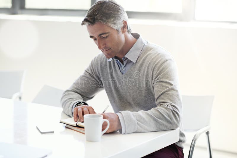 Getting Down To Business. Shot of a Businessman at Work in an Office ...