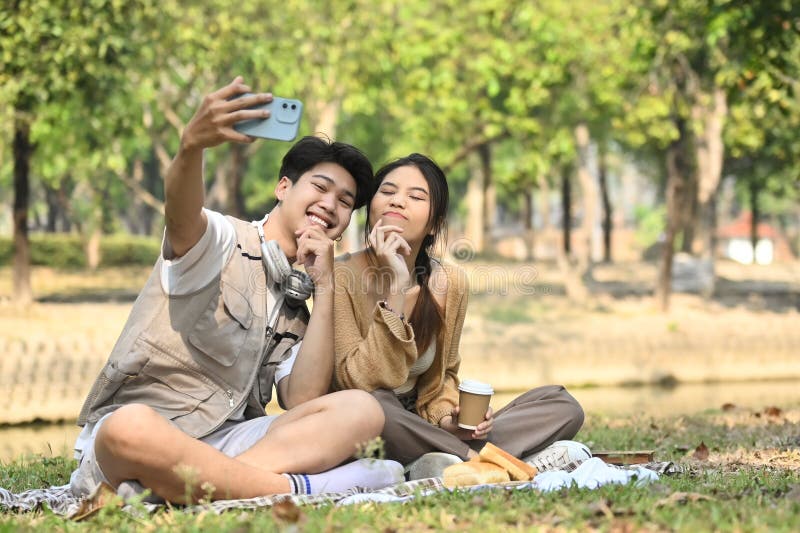 Shot of Cheerful Male and Female Lovers Taking Selfie with Smartphone ...
