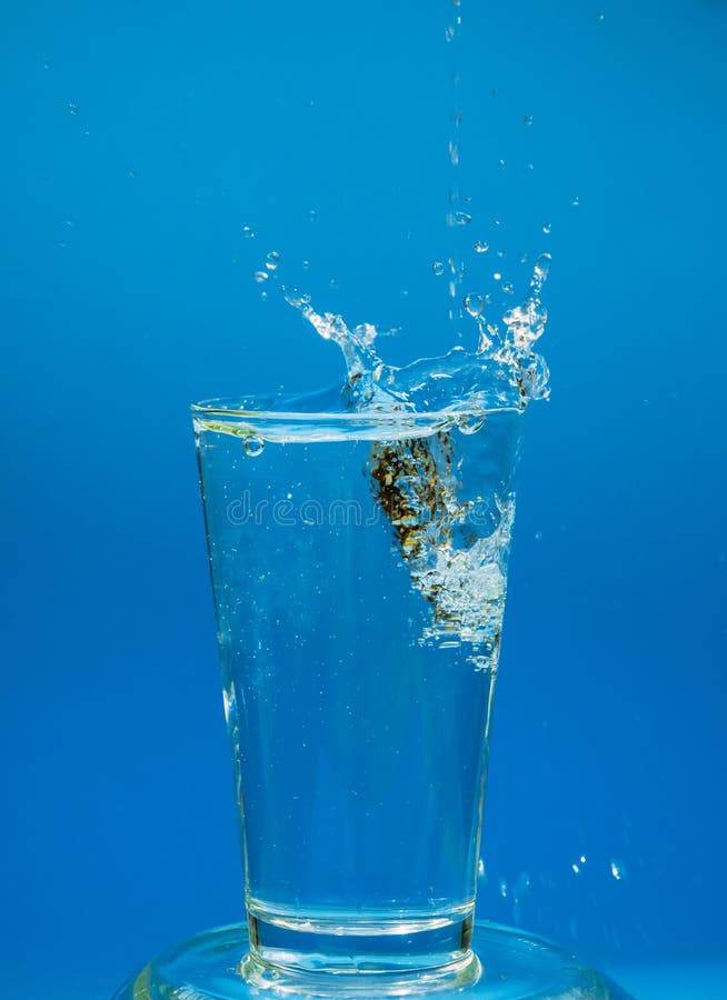 Clear Water is Poured into a Glass Beaker Splashing Around Stock Photo ...