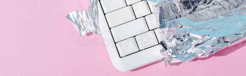 Shot of Computer Keyboard Wrapped in Silver Foil on Pink, Chocolate Bar ...