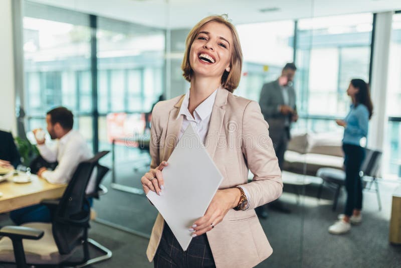 Confident Young Businesswoman Standing in a Modern Office Stock Image ...