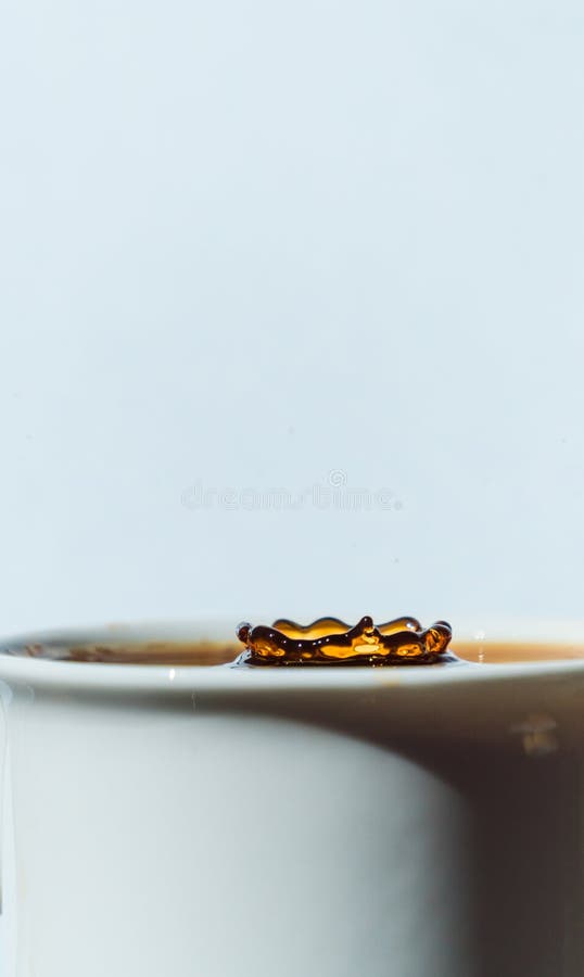 A Drop of Coffee Falls into a White Porcelain Mug Full of Freshly ...