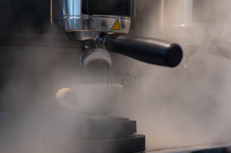 A Shot of Espresso from Espresso Coffee Machine with Steam from the ...