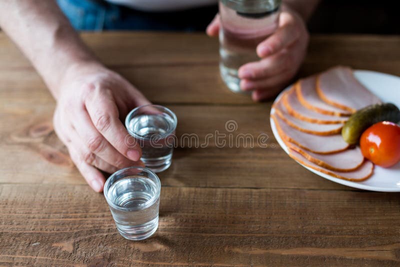 Shot Glasses of Vodka on a Wooden Table Stock Image - Image of bottle ...