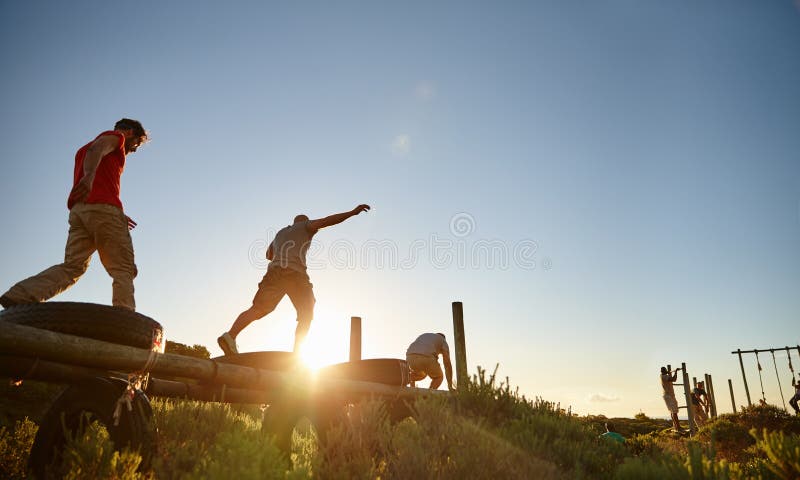 Putting in 100. Shot of a Group of Men Going through an Obstacle Course ...