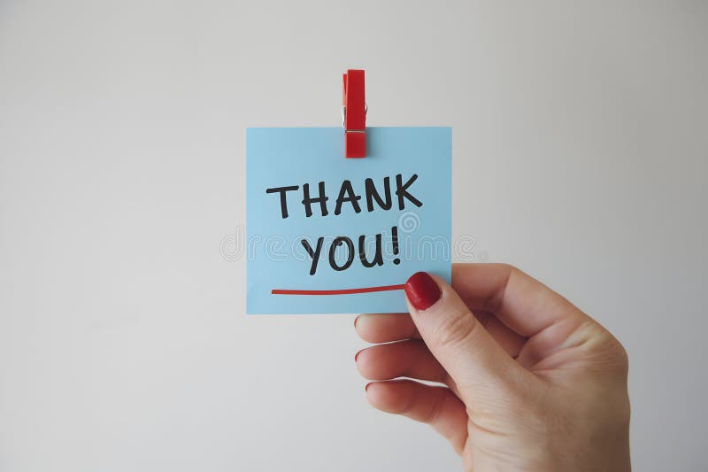 Hand Holds THANK YOU! Note Secured with Red Clothespin on White ...