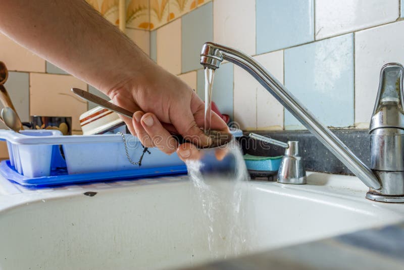 Human hand washing a spoon stock photo. Image of detergent - 189373142