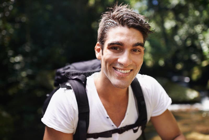 Getting Away from it All. Shot of a Handsome Young Man Hiking in the ...
