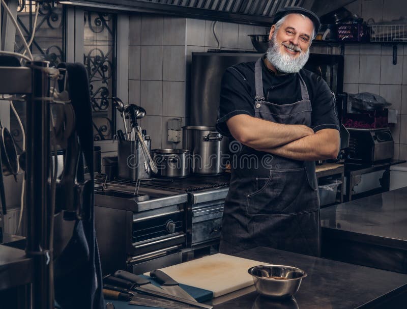 Joyful Elderly Chef with Apron and Cap Posing with Crossed Arms Stock ...