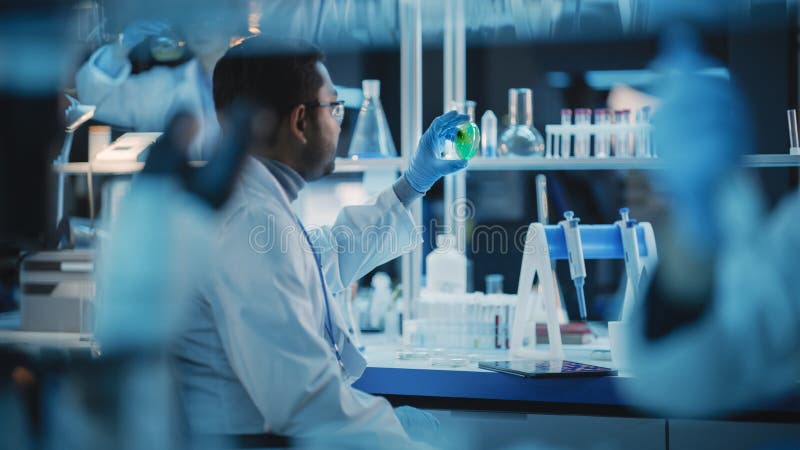 Shot of an Indian Male Working on DNA, Analyzing Green Samples in a ...