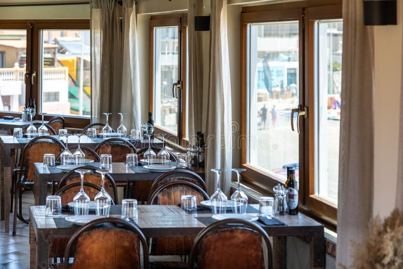 Shot of the Inside of an Empty Restaurant with Wine Glasses on the ...
