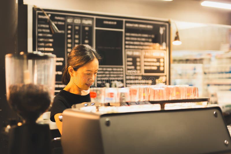 Shot in Low Light of Female Barista Making a Fresh Coffee in Cafe ...