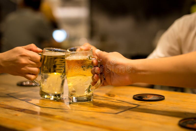 Shot in Low Light Friends Toasting with Glasses Beer at the Pub. Stock ...