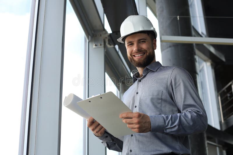 Shot of Male Architect Wearing Hardhat and Inspecting New Building ... Shot of Male Architect Wearing Hardhat and Inspecting New Building ...