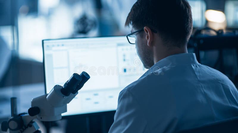 Shot of a Male it Scientist Uses Computer with Electronic Microscope ...