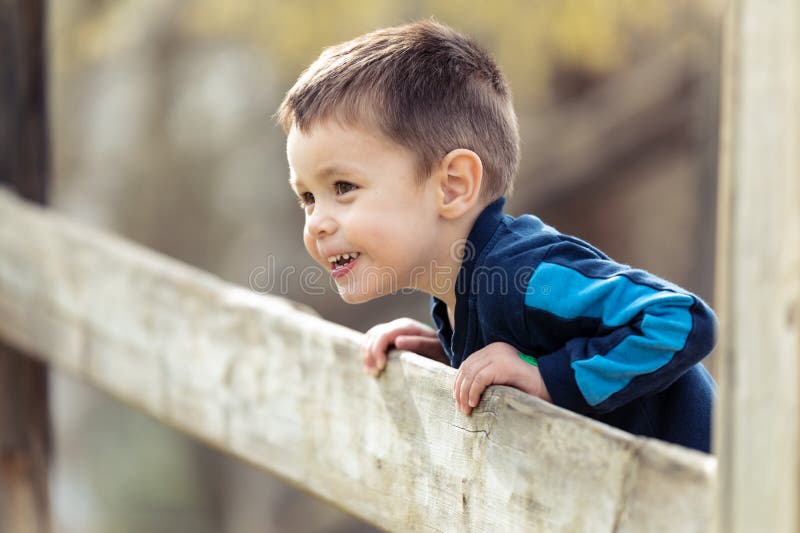 Nice Little Boy Looking Forward from the Bridge Outdoors Stock Photo ...