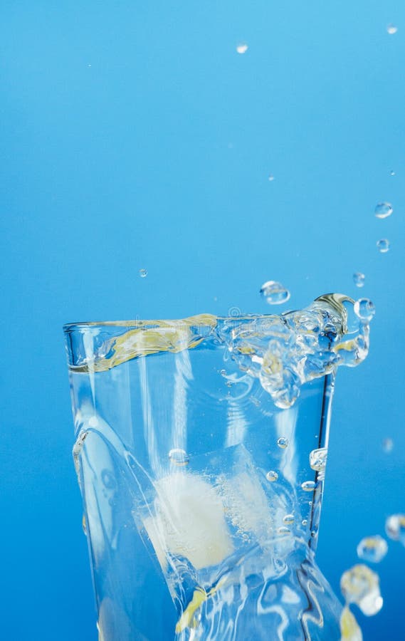 An Ice Cube Falls Into A Glass Of Clean Drinking Water Splashing It Around Stock Image Image
