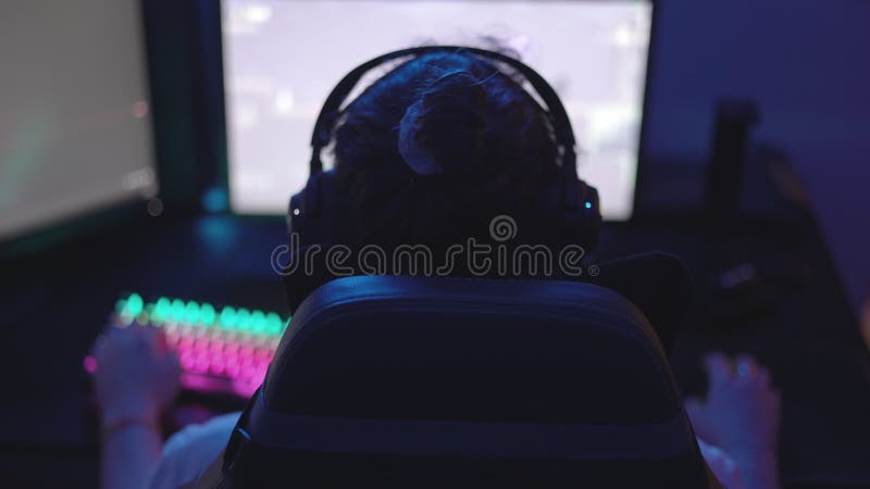 Shot of a Person with a Bun, Seen from Behind, Sitting and Playing on ...