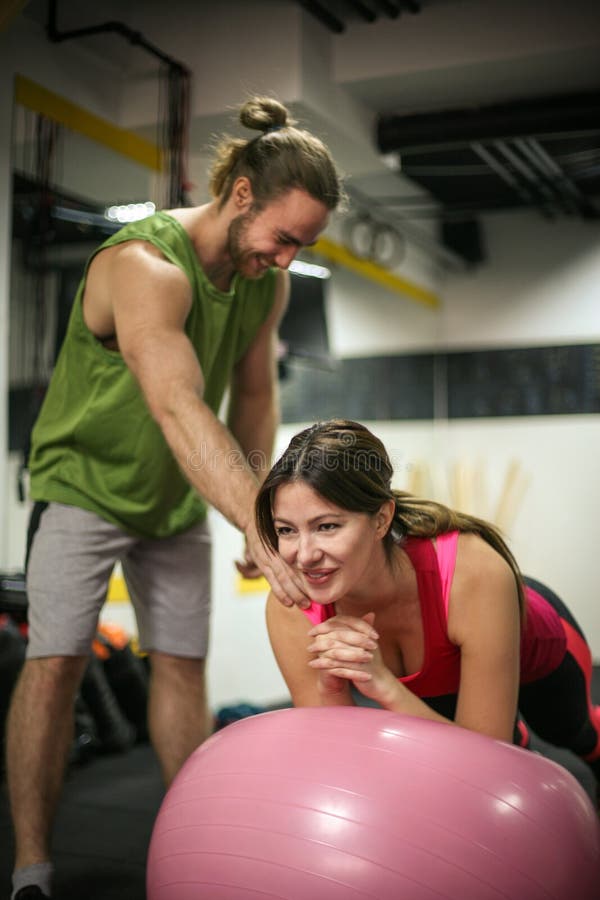 Personal Trainer Training His Client in the Gym. Stock Photo - Image of ...