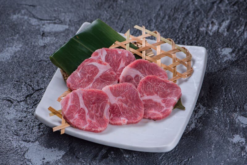 Shot of Raw Beef Meat Pieces on the White Plate with Dark Background ...