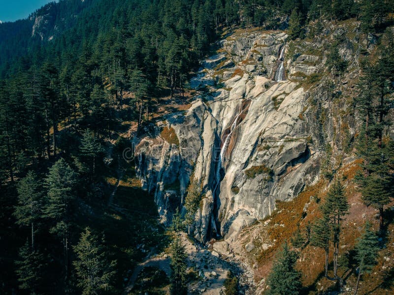 Shot of River Falling Down through the Rocky Mountains Surrounded by ...