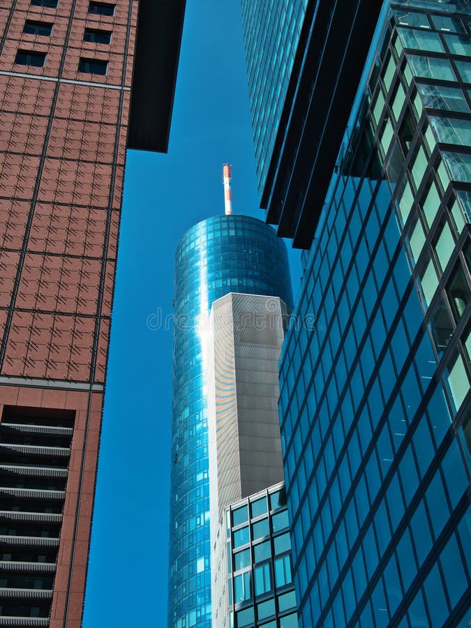 The Shot of a Round Skyscraper between Other Skyscrapers with a Blue ...