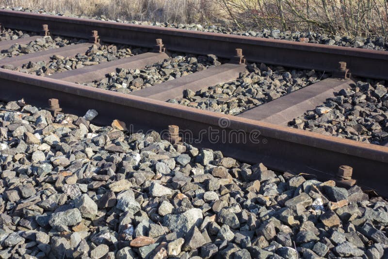 Shot of Rusty Metal Train Tracks Surrounded by Rocks. Stock Image ...