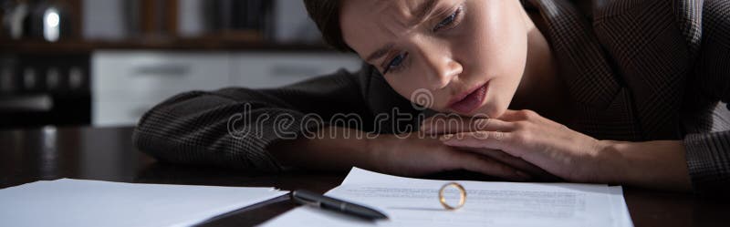 Shot of Sad Woman at Table with Ring and Documents Stock Photo - Image ...