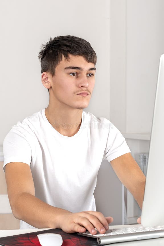 Shot of a Serious Teenager Guy Using Computer Stock Photo - Image of ...