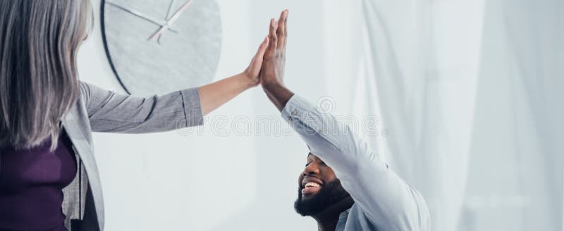 Shot of Smiling Multicultural Colleagues Giving Stock Photo - Image of ...