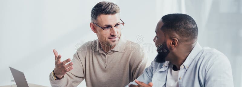 Shot of Smiling Multicultural Colleagues Talking Stock Photo - Image of ...