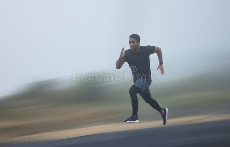 Picking Up the Pace. Shot of a Sporty Young Man Running Outdoors. Stock ...