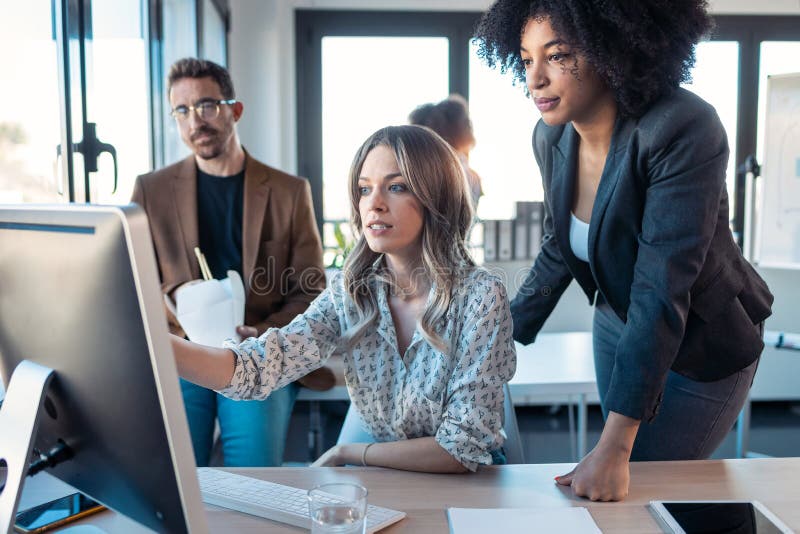 Successful Business Multiage Team Standing Around Computer for ...