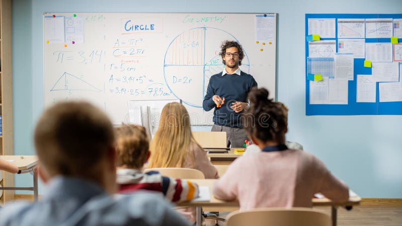 Shot of Teacher Explaining Lesson To Classroom Full of Diverse Bright ...